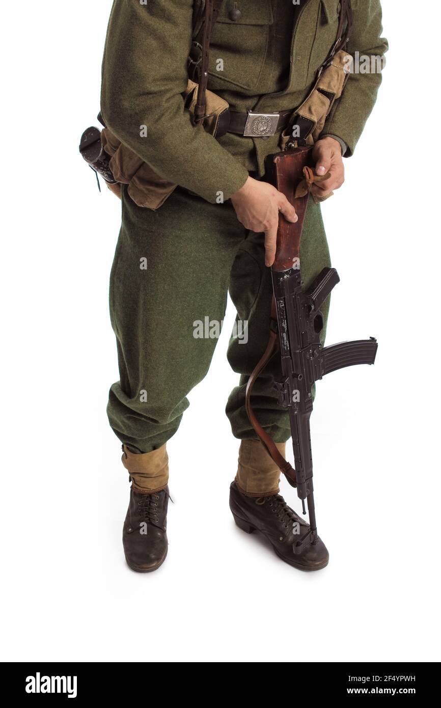 Man actor in the movie role of an military man with a machine gun ...