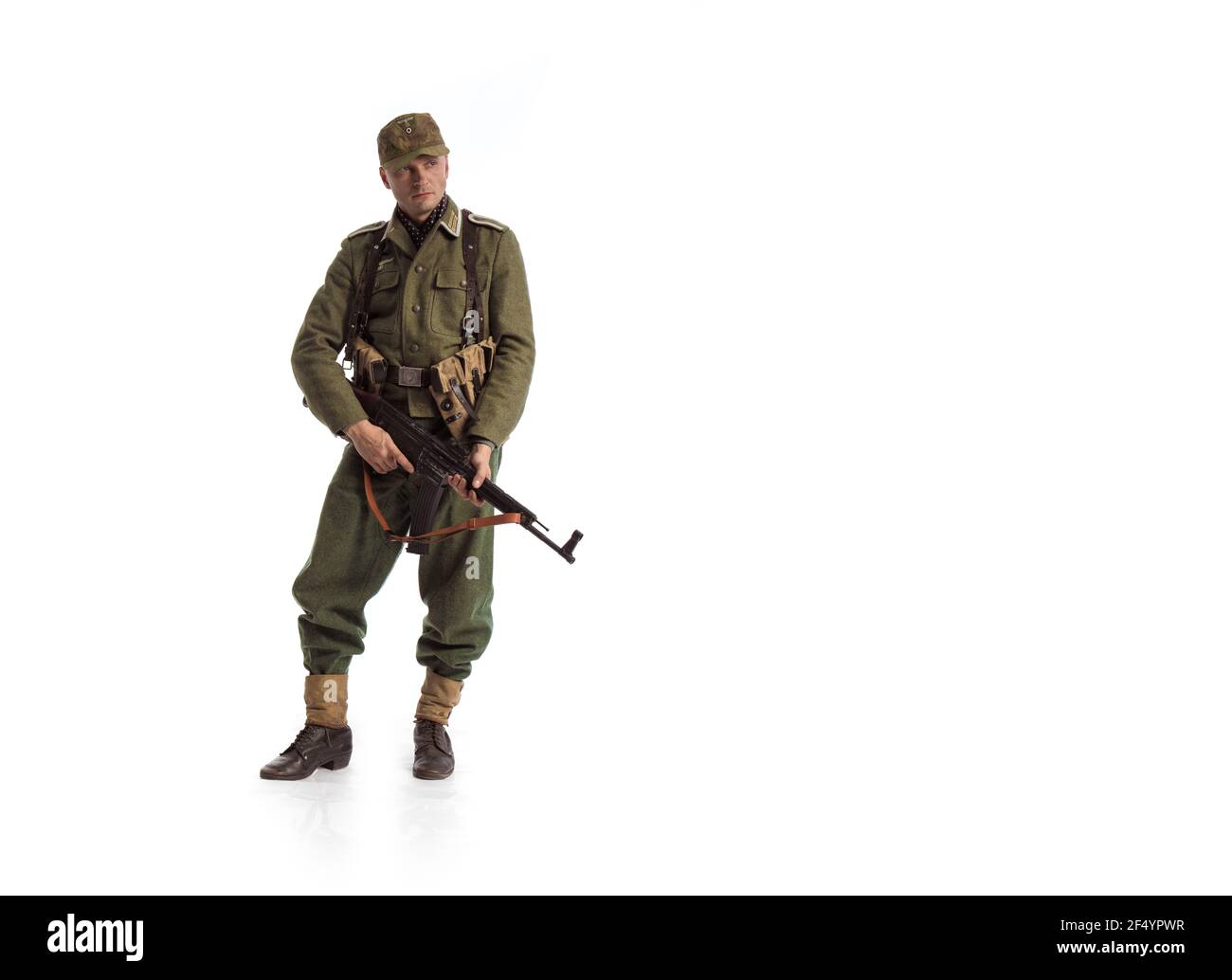 Man actor in the movie role of an military man with a machine gun ...