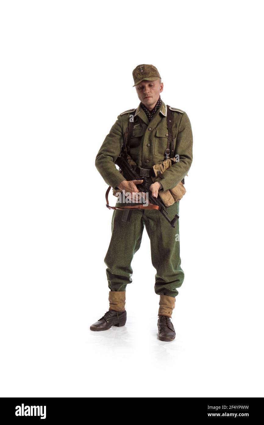 Man actor in the movie role of an military man with a machine gun ...