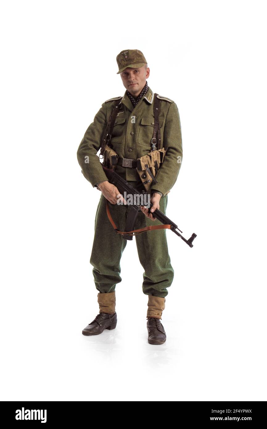 Man actor in the movie role of an military man with a machine gun ...