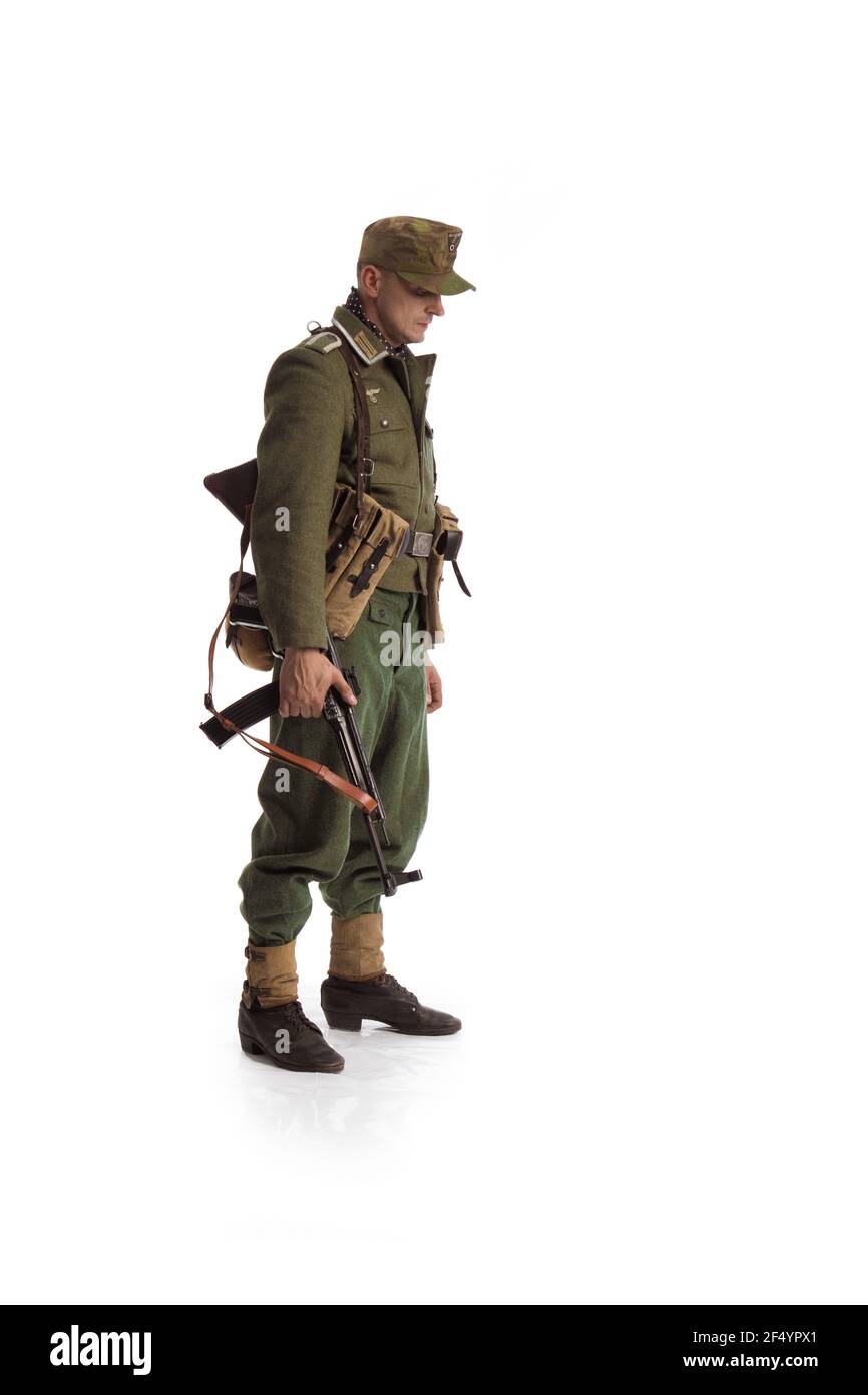 Man actor in the movie role of an military man with a machine gun ...