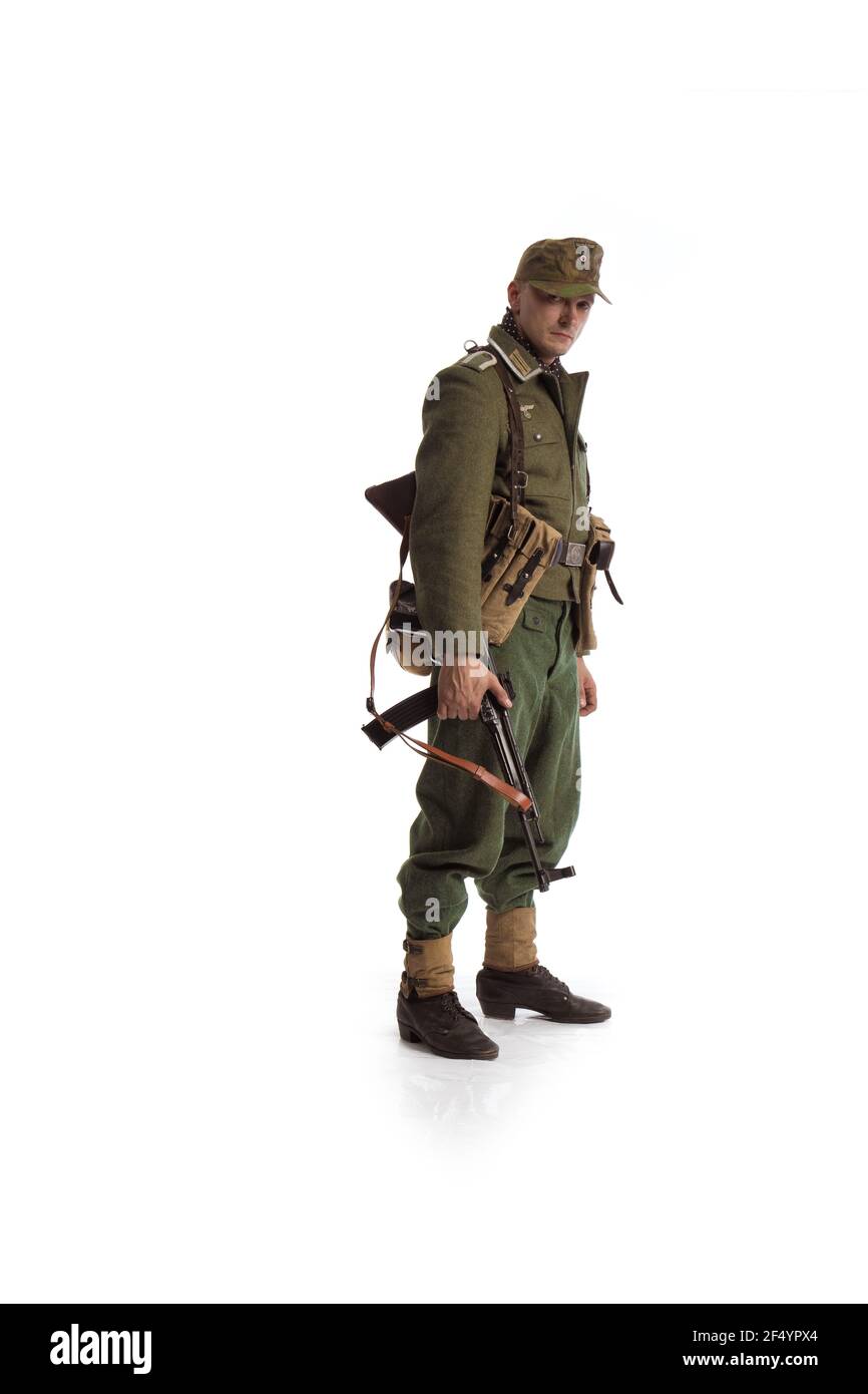 Man actor in the movie role of an military man with a machine gun ...