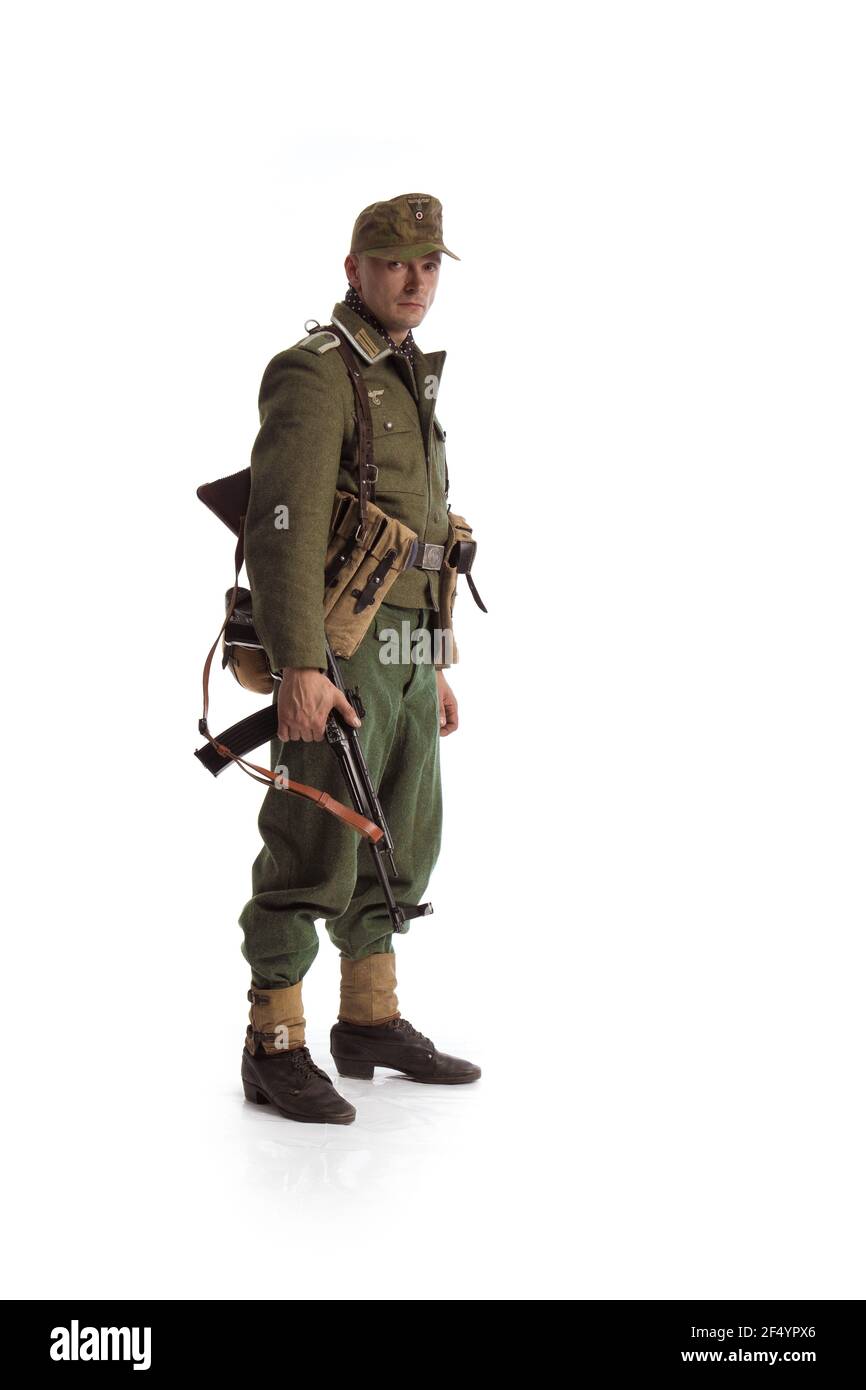 Man actor in the movie role of an military man with a machine gun ...