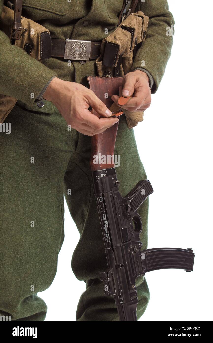 Man actor in the movie role of an military man with a machine gun ...