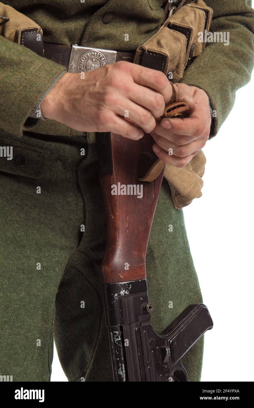 Man actor in the movie role of an military man with a machine gun ...