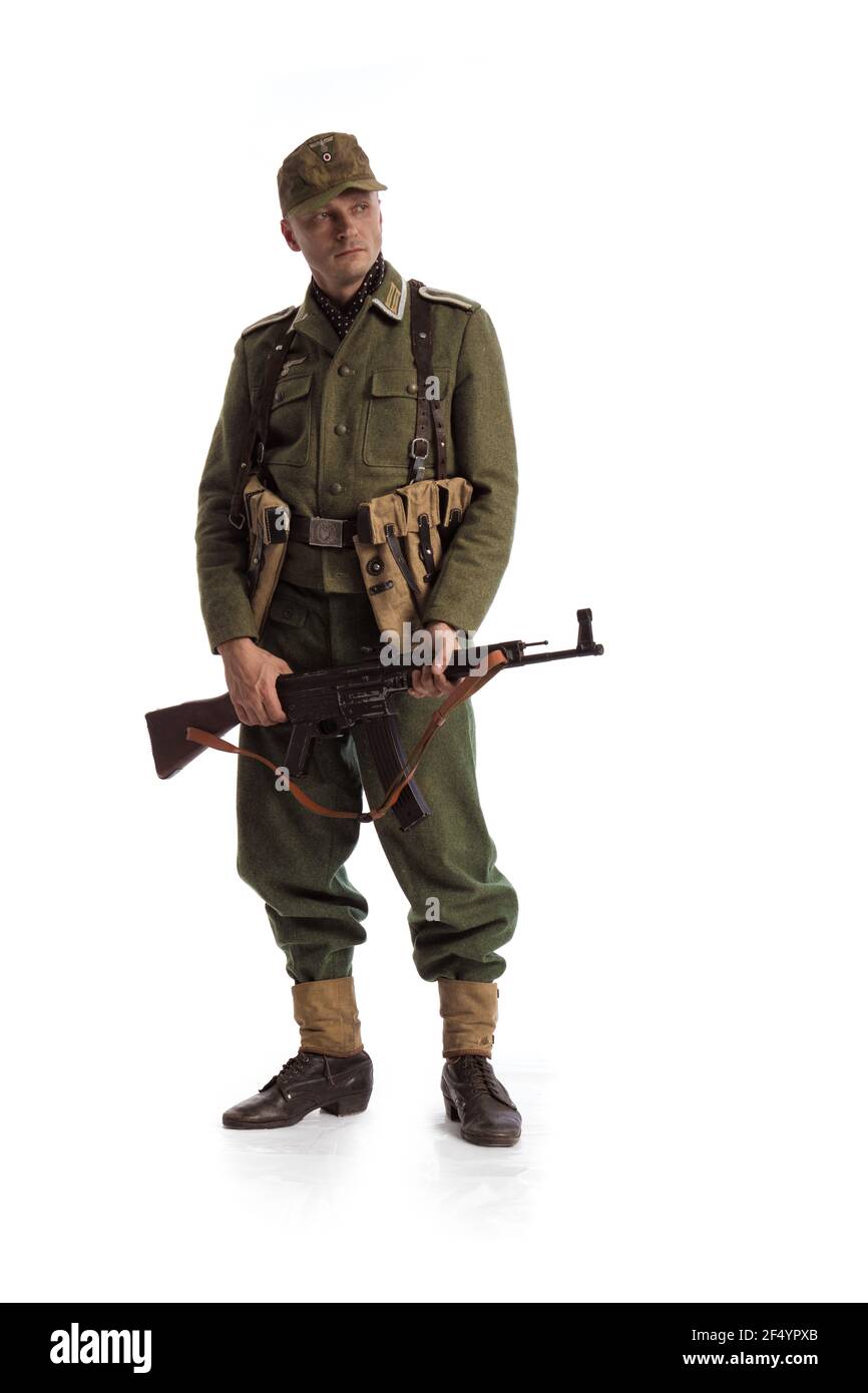 Man actor in the movie role of an military man with a machine gun ...