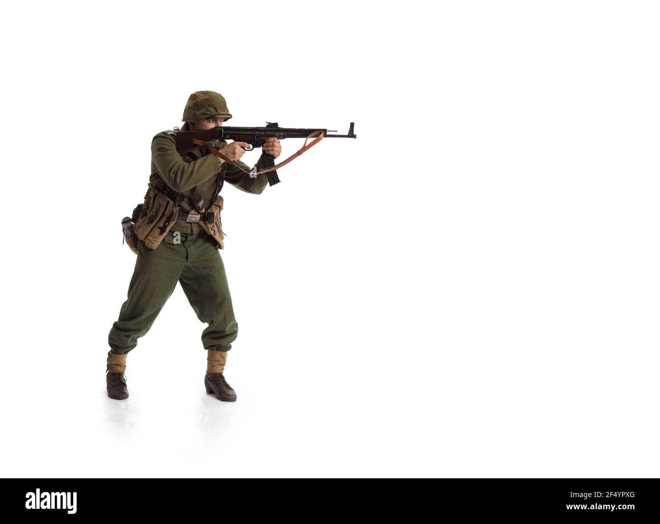 Man actor in the movie role of an military man with a machine gun ...