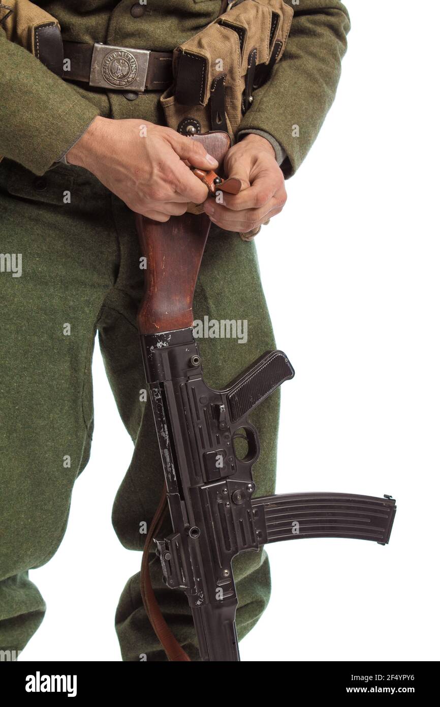 Man actor in the movie role of an military man with a machine gun ...