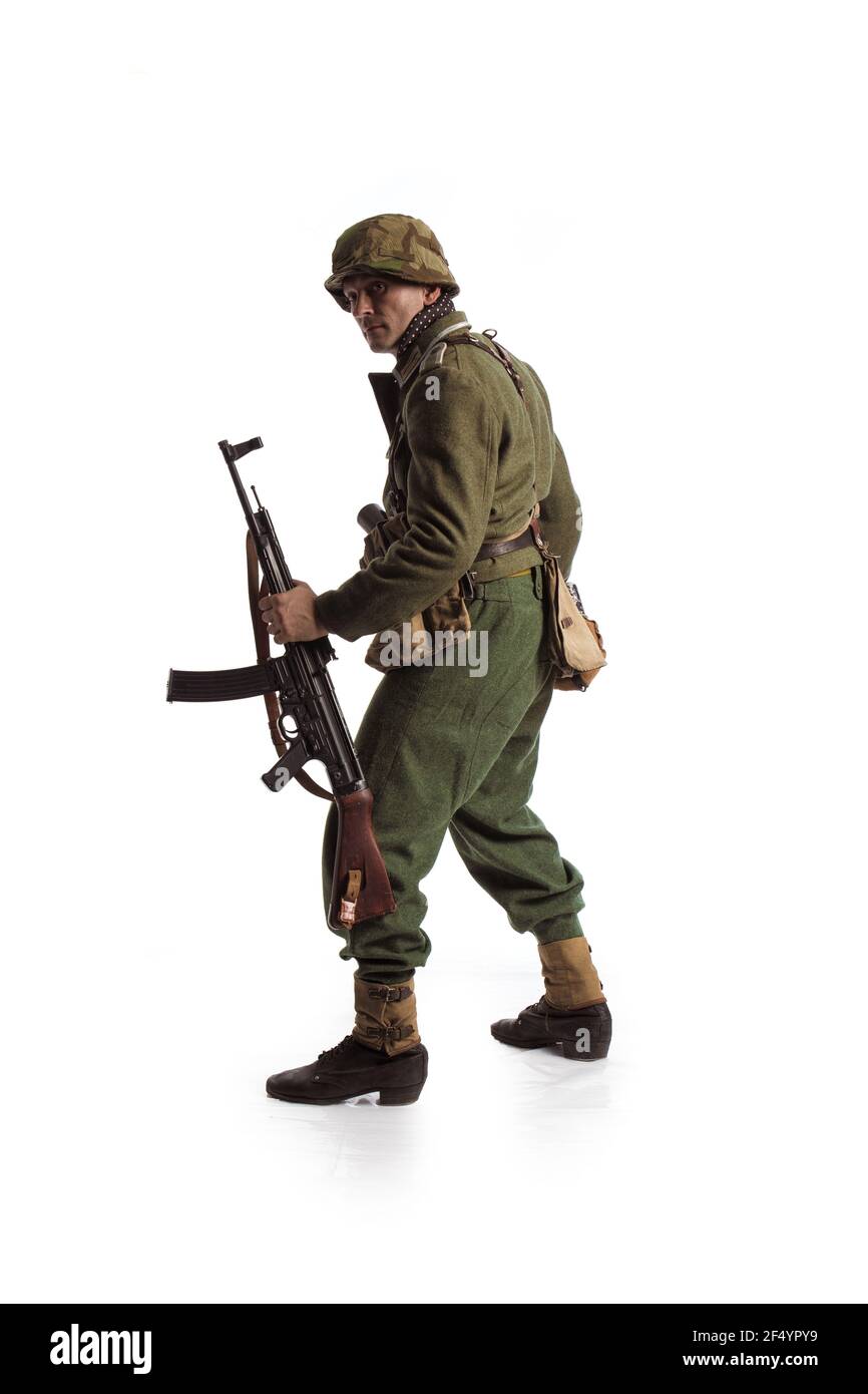 Man actor in the movie role of an military man with a machine gun ...