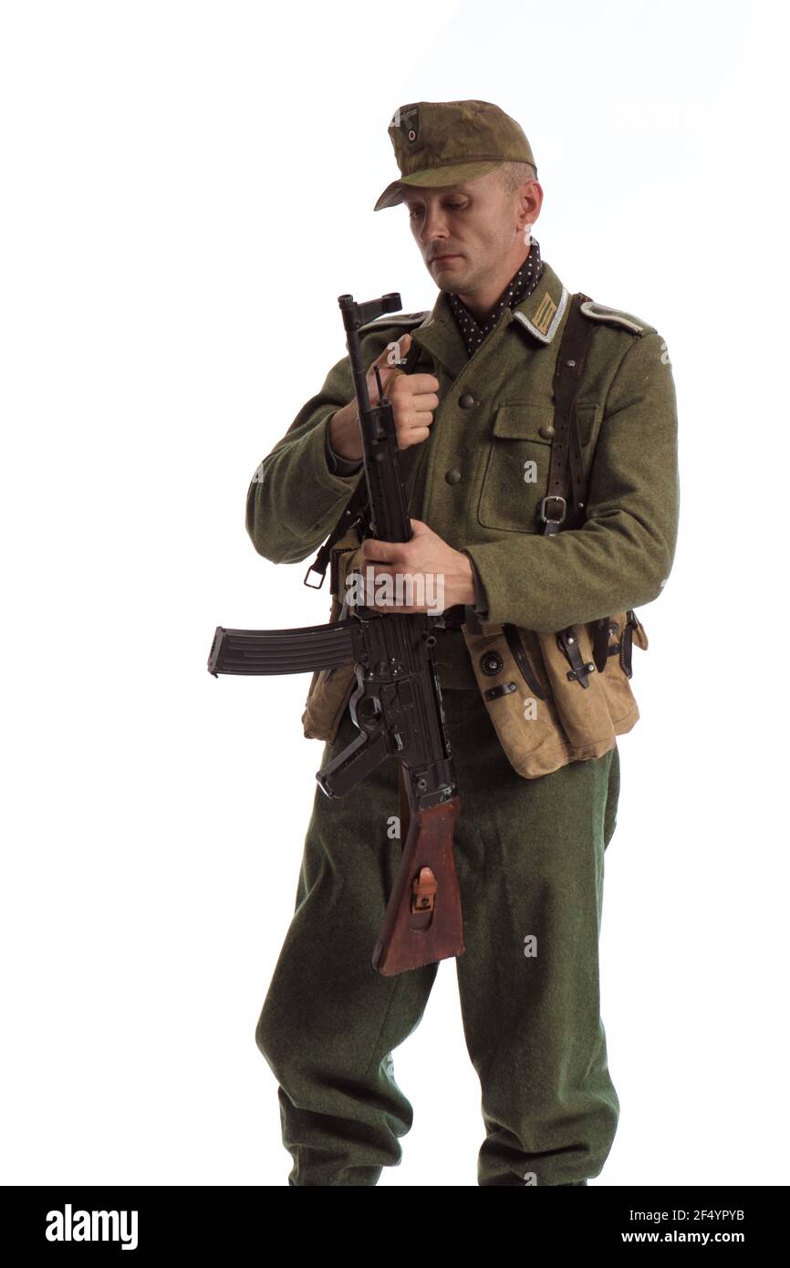 Man actor in the movie role of an military man with a machine gun ...