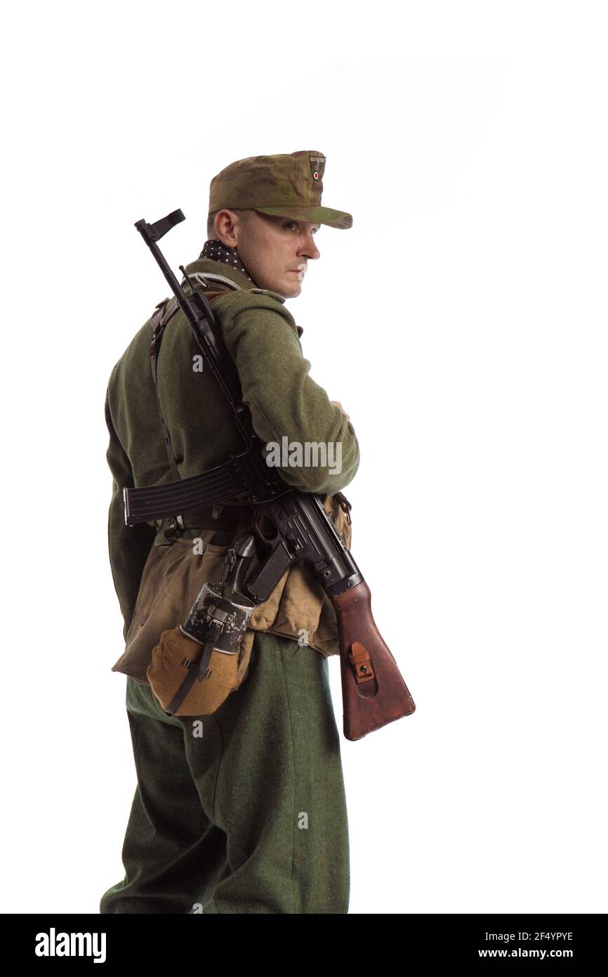 Man actor in the movie role of an military man with a machine gun ...