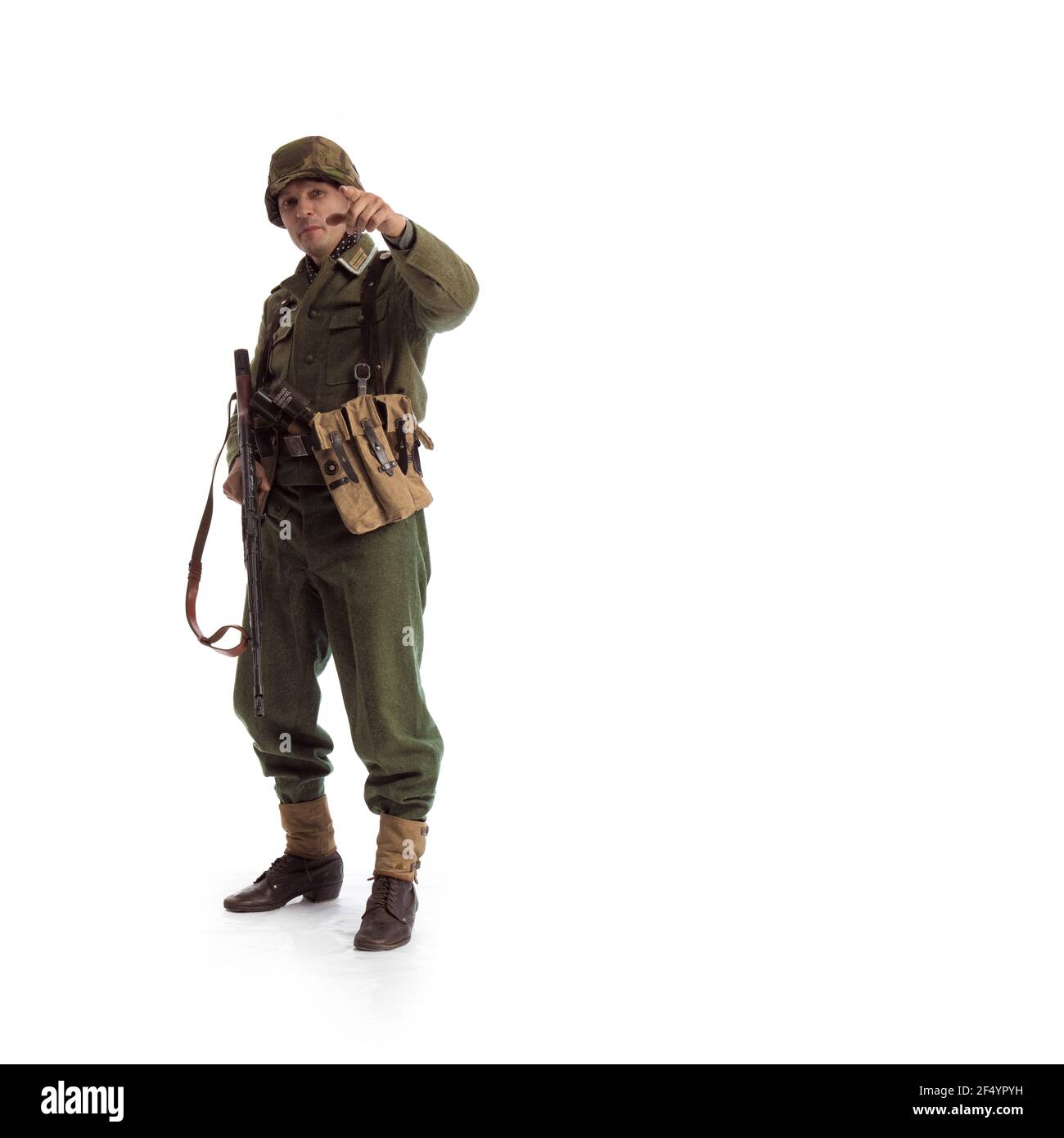 Man actor in the movie role of an military man with a machine gun ...