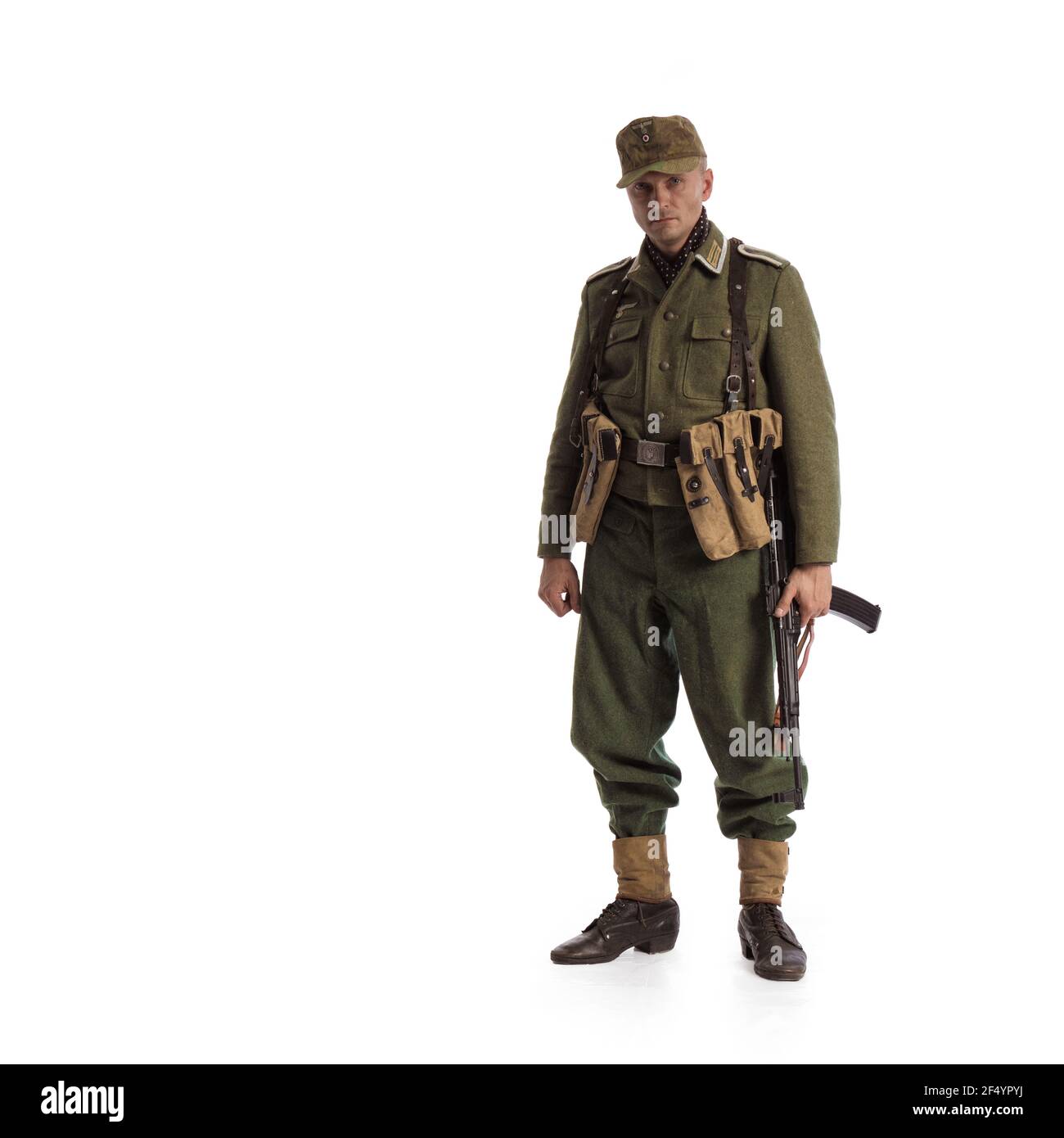 Man actor in the movie role of an military man with a machine gun ...