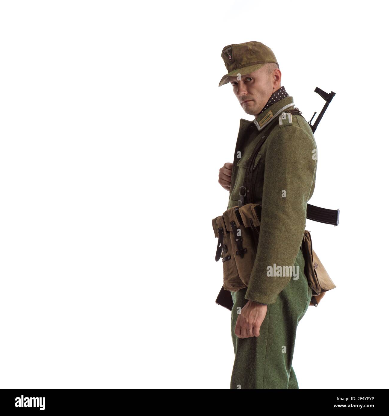 Man actor in the movie role of an military man with a machine gun ...