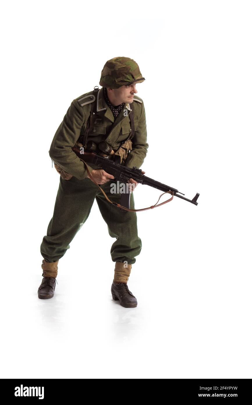 Man actor in the movie role of an military man with a machine gun ...