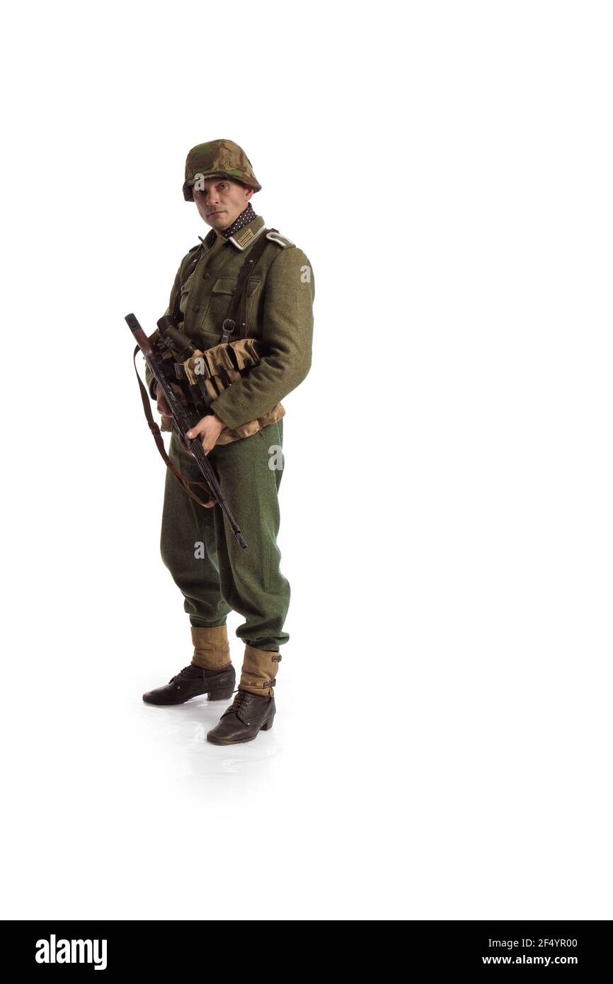 Man actor in the movie role of an military man with a machine gun ...