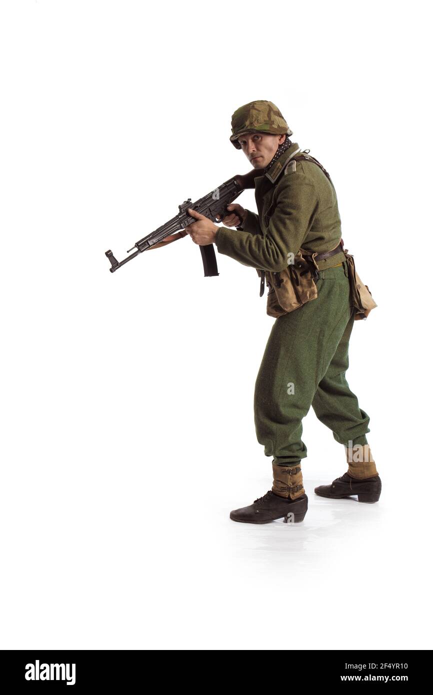 Man actor in the movie role of an military man with a machine gun ...