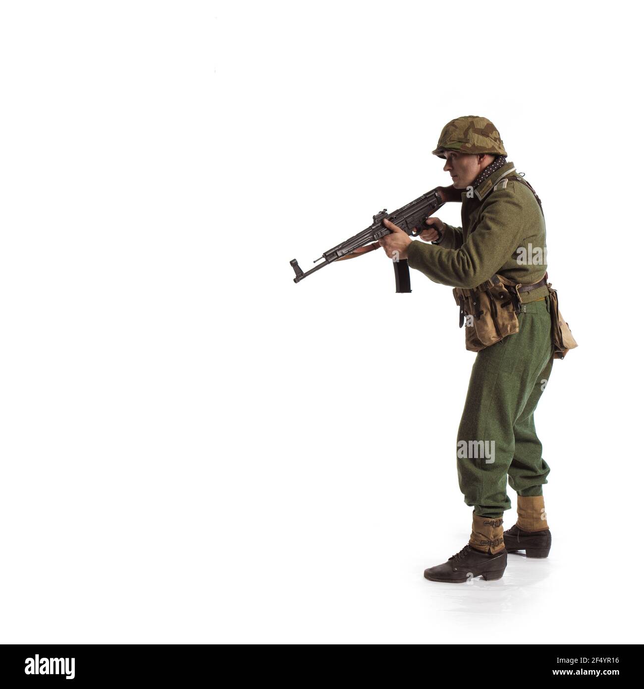 Man actor in the movie role of an military man with a machine gun ...