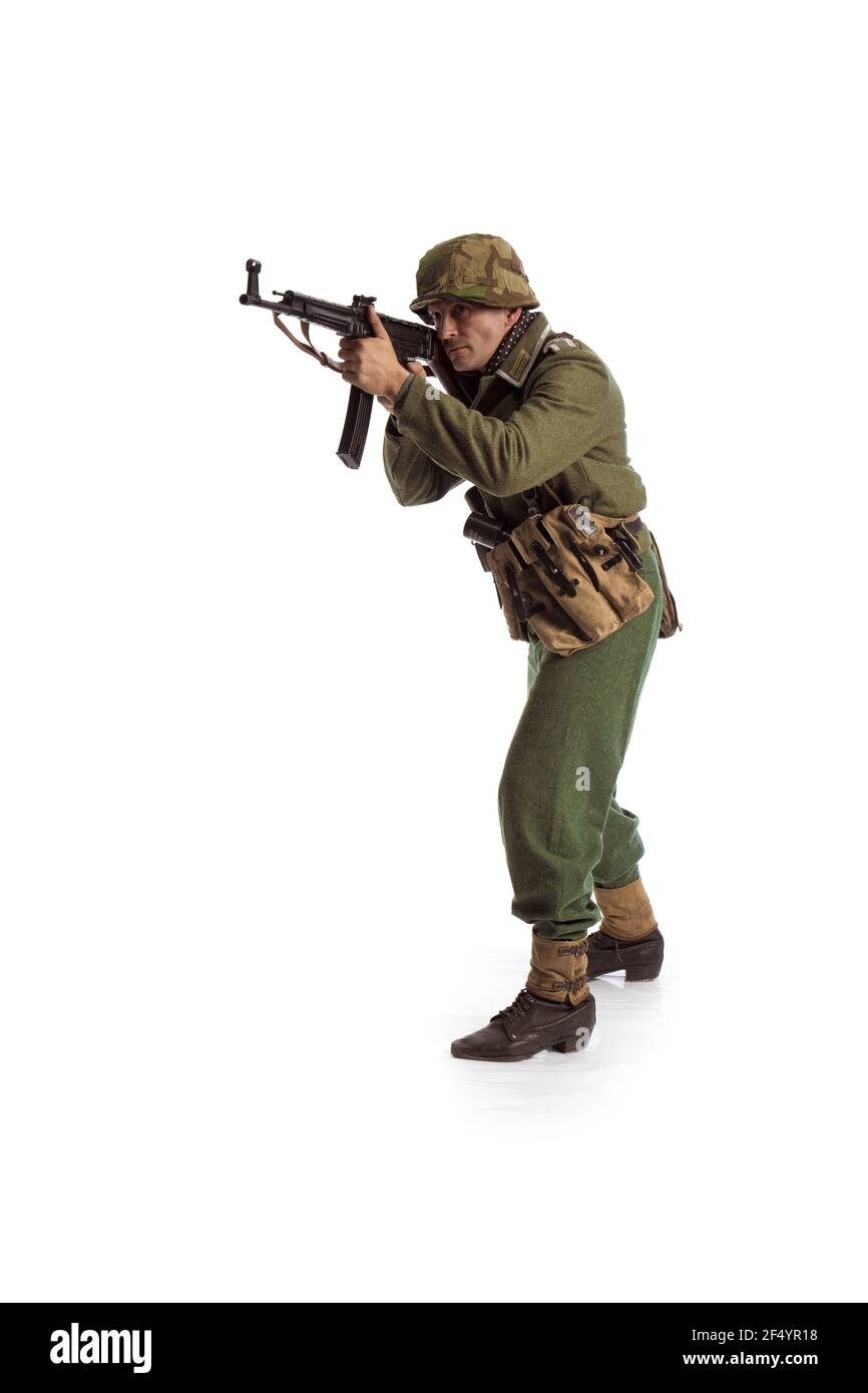 Man actor in the movie role of an military man with a machine gun ...