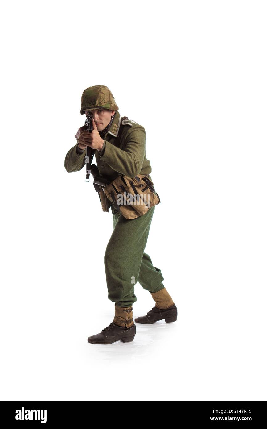 Man actor in the movie role of an military man with a machine gun ...