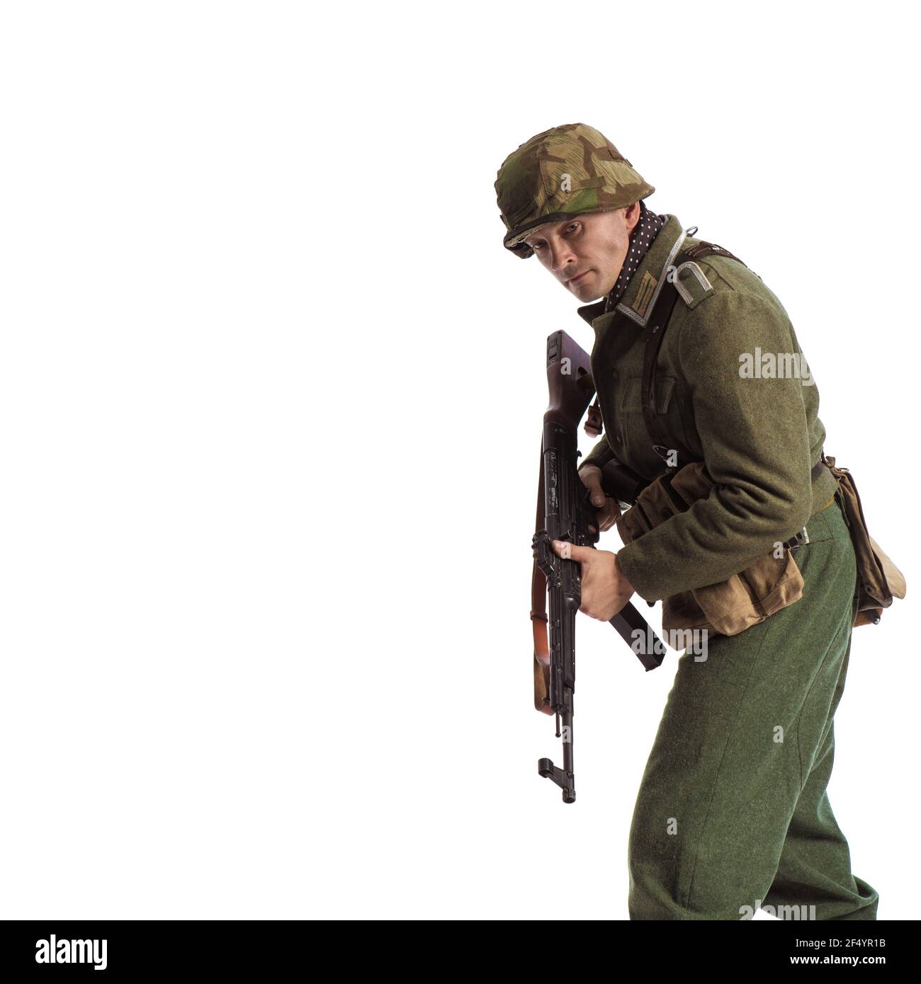 Man actor in the movie role of an military man with a machine gun ...