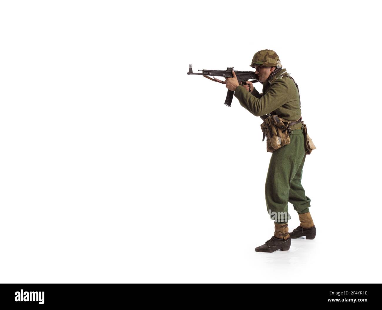 Man actor in the movie role of an military man with a machine gun ...