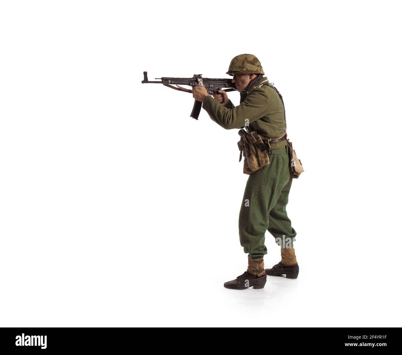 Man actor in the movie role of an military man with a machine gun ...