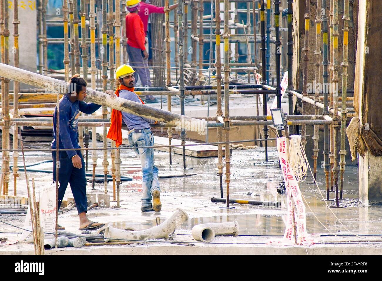 construction site in india at dusk with workers, people, labor ...