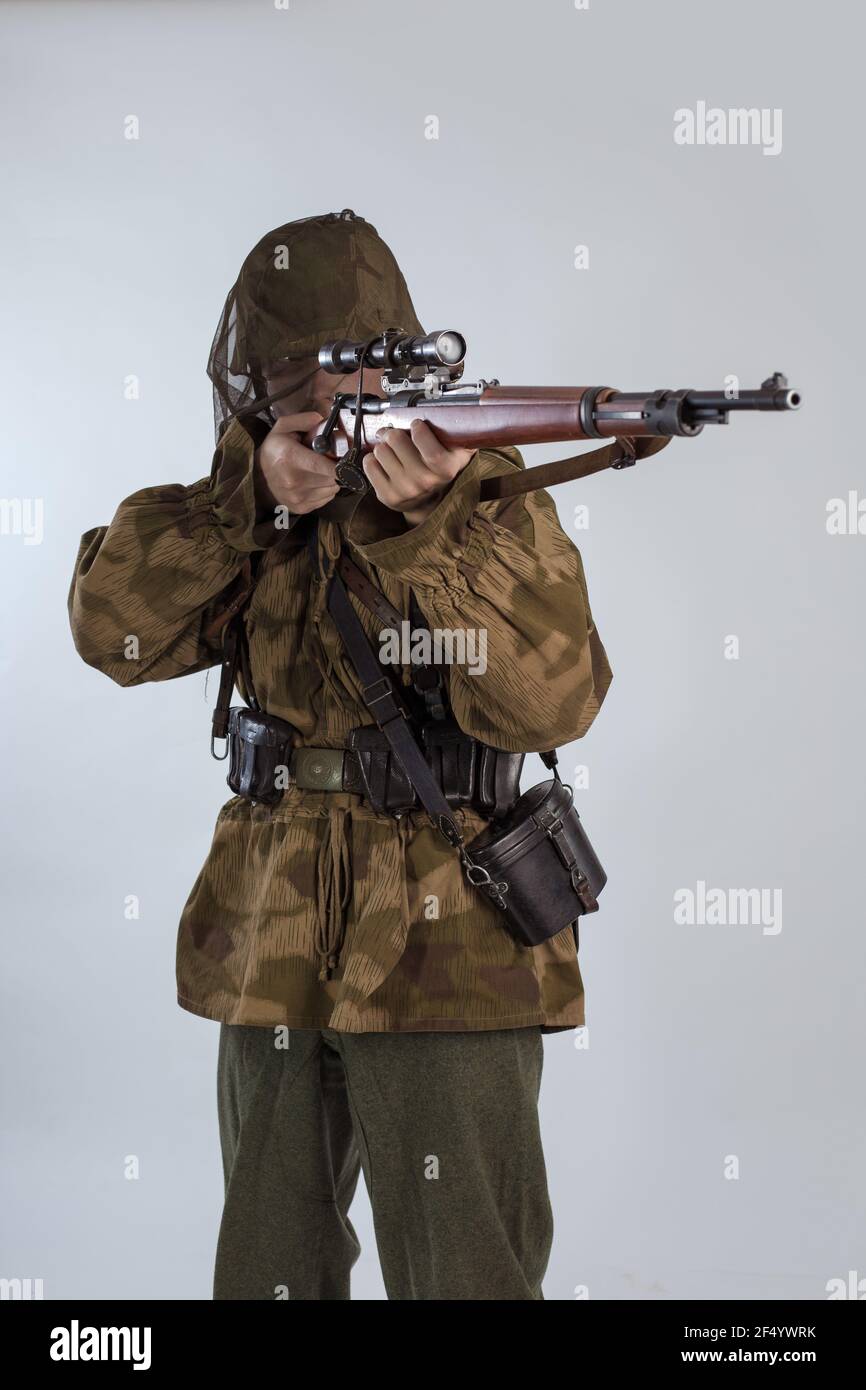 Actor man in an old military uniform and camouflage sniper marksman ...