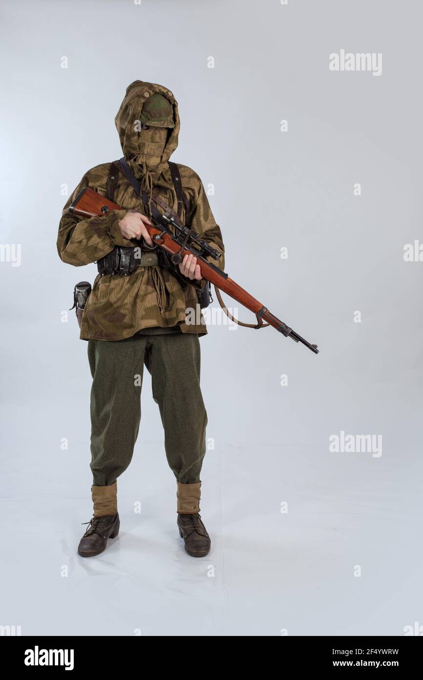 Actor man in an old military uniform and camouflage sniper marksman ...