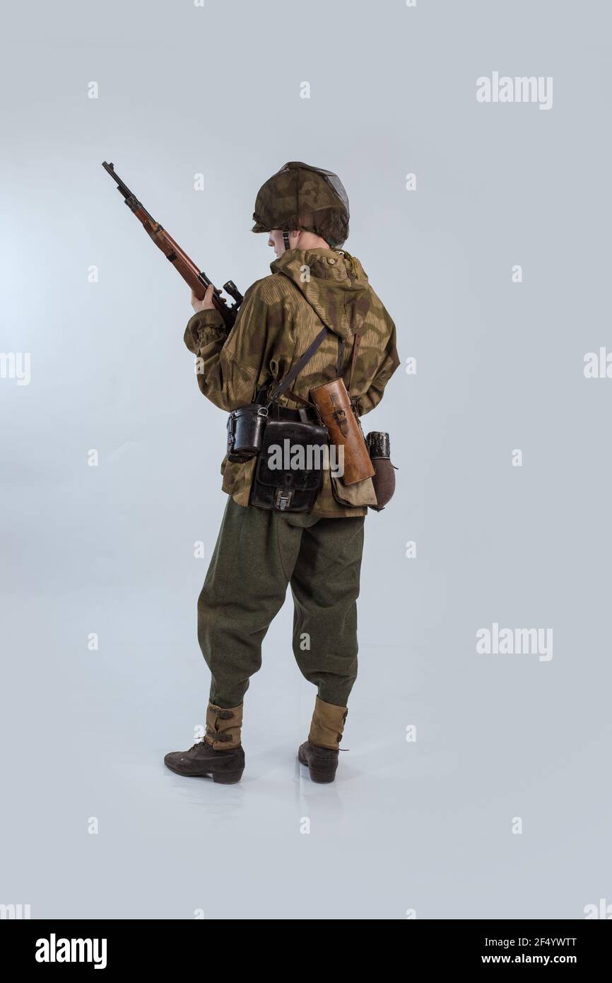 Actor man in an old military uniform and camouflage sniper marksman ...