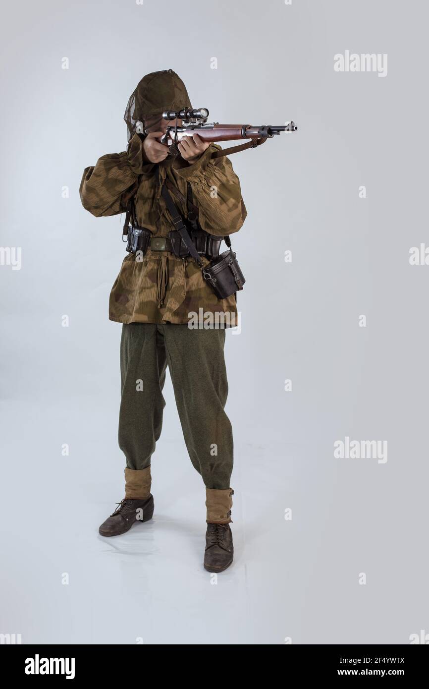 Actor man in an old military uniform and camouflage sniper marksman ...