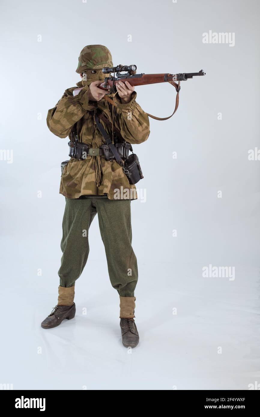 Actor man in an old military uniform and camouflage sniper marksman ...