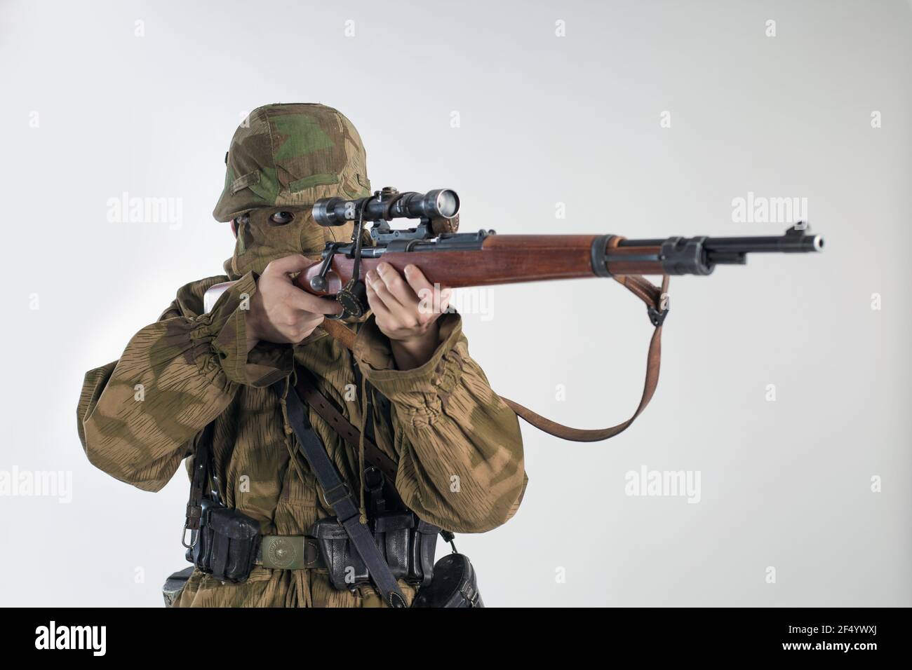 Actor man in an old military uniform and camouflage sniper marksman ...