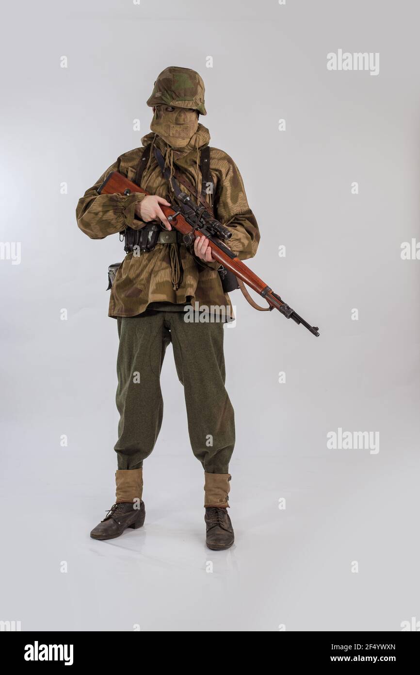 Actor man in an old military uniform and camouflage sniper marksman ...