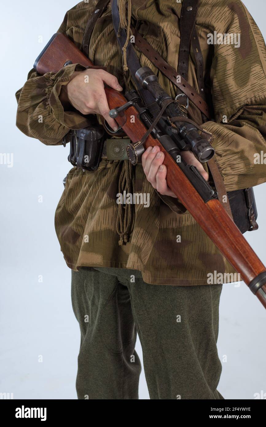 Actor man in an old military uniform and camouflage sniper marksman ...