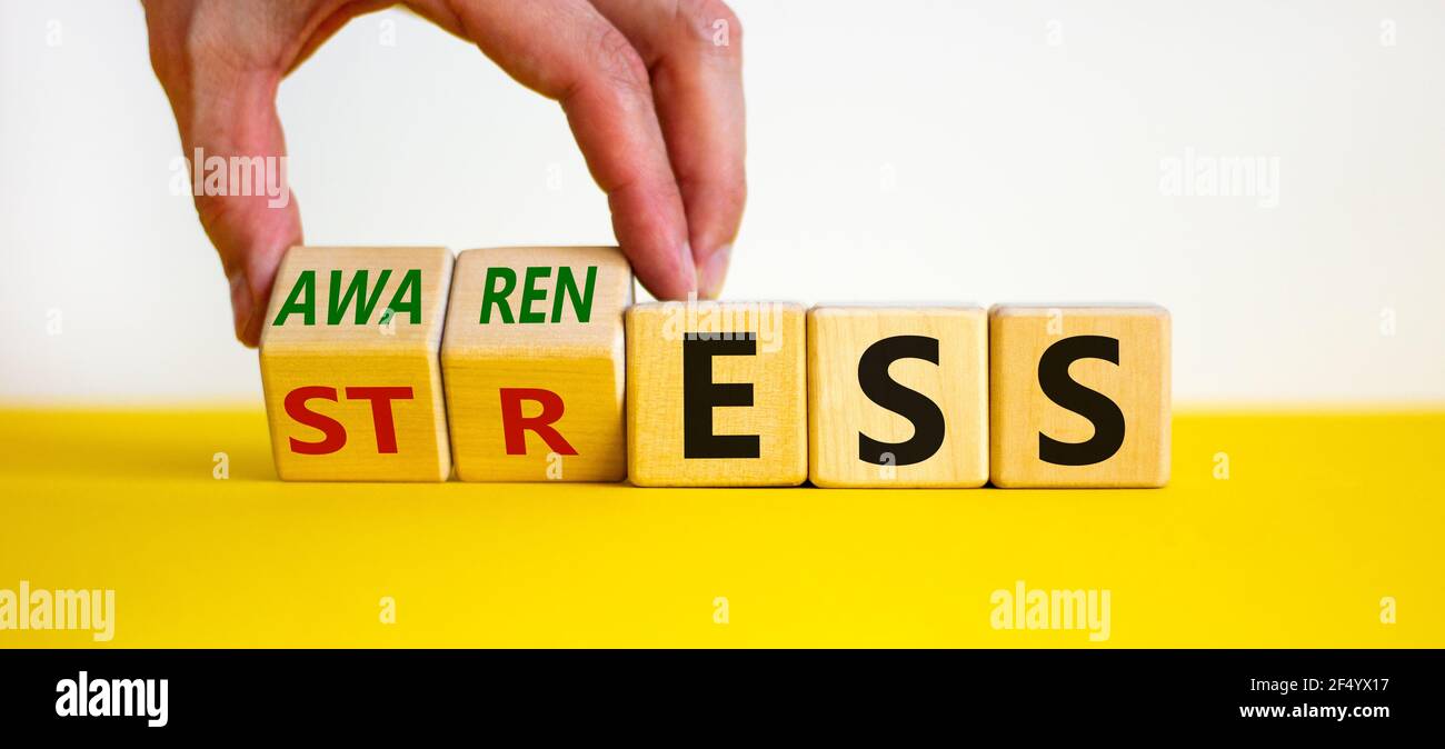 Stress awareness symbol. Businessman turns cubes and changes the word ...