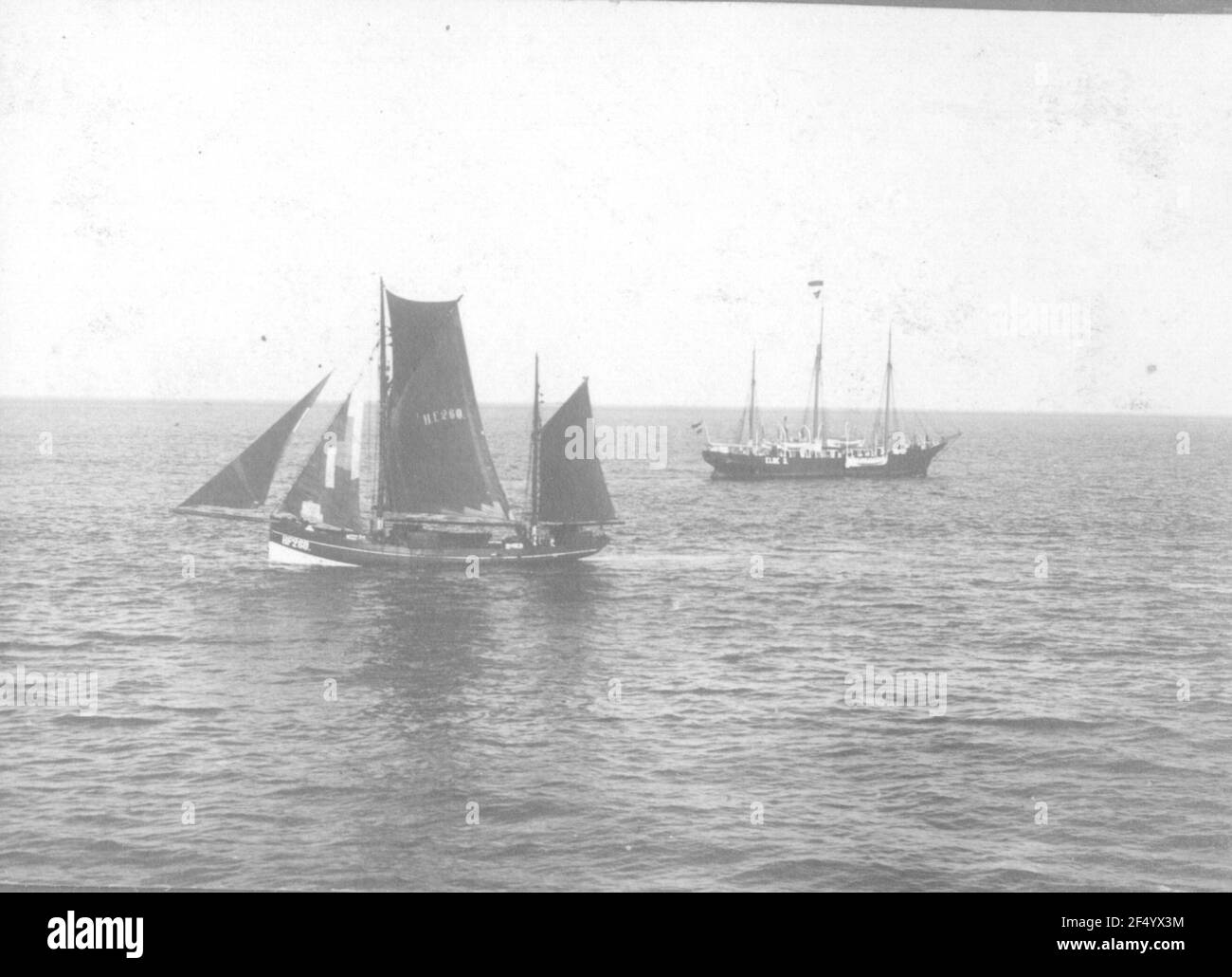 Two-mast sailboat passes along longitudinal distance. In the middle ...