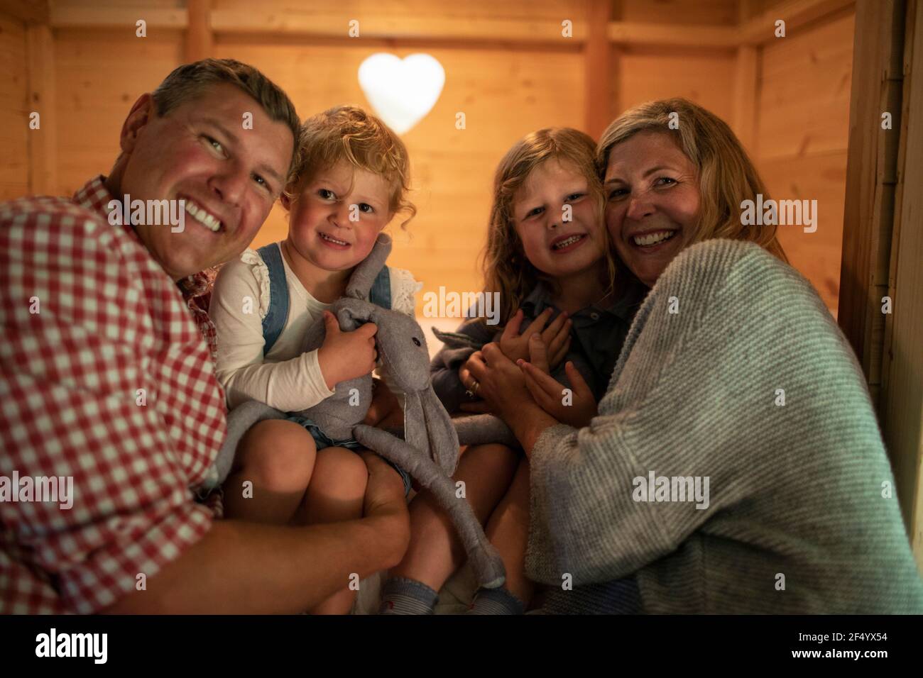 Portrait happy parents and daughters hugging Stock Photo - Alamy