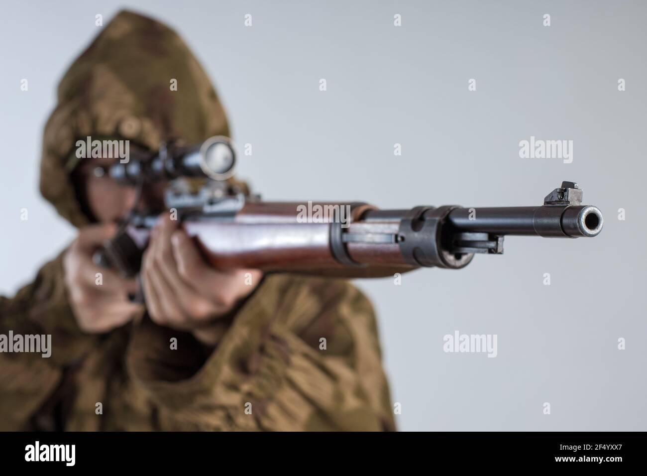 Actor man in an old military uniform and camouflage sniper marksman ...