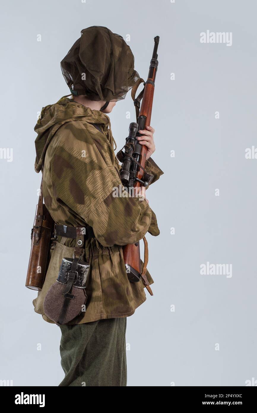 Actor man in an old military uniform and camouflage sniper marksman ...