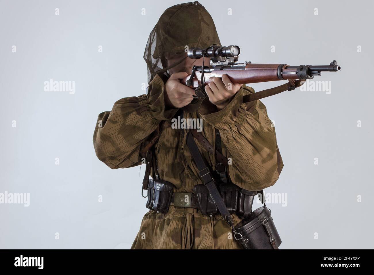 Actor man in an old military uniform and camouflage sniper marksman ...