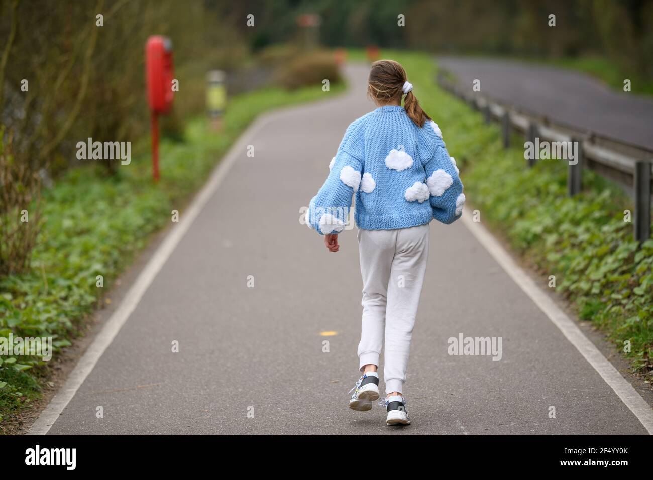 Girl running on a path Stock Photo - Alamy
