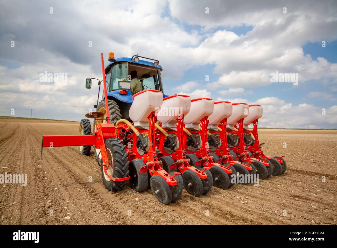 tractor sowing of seed to field at spring time Stock Photo - Alamy
