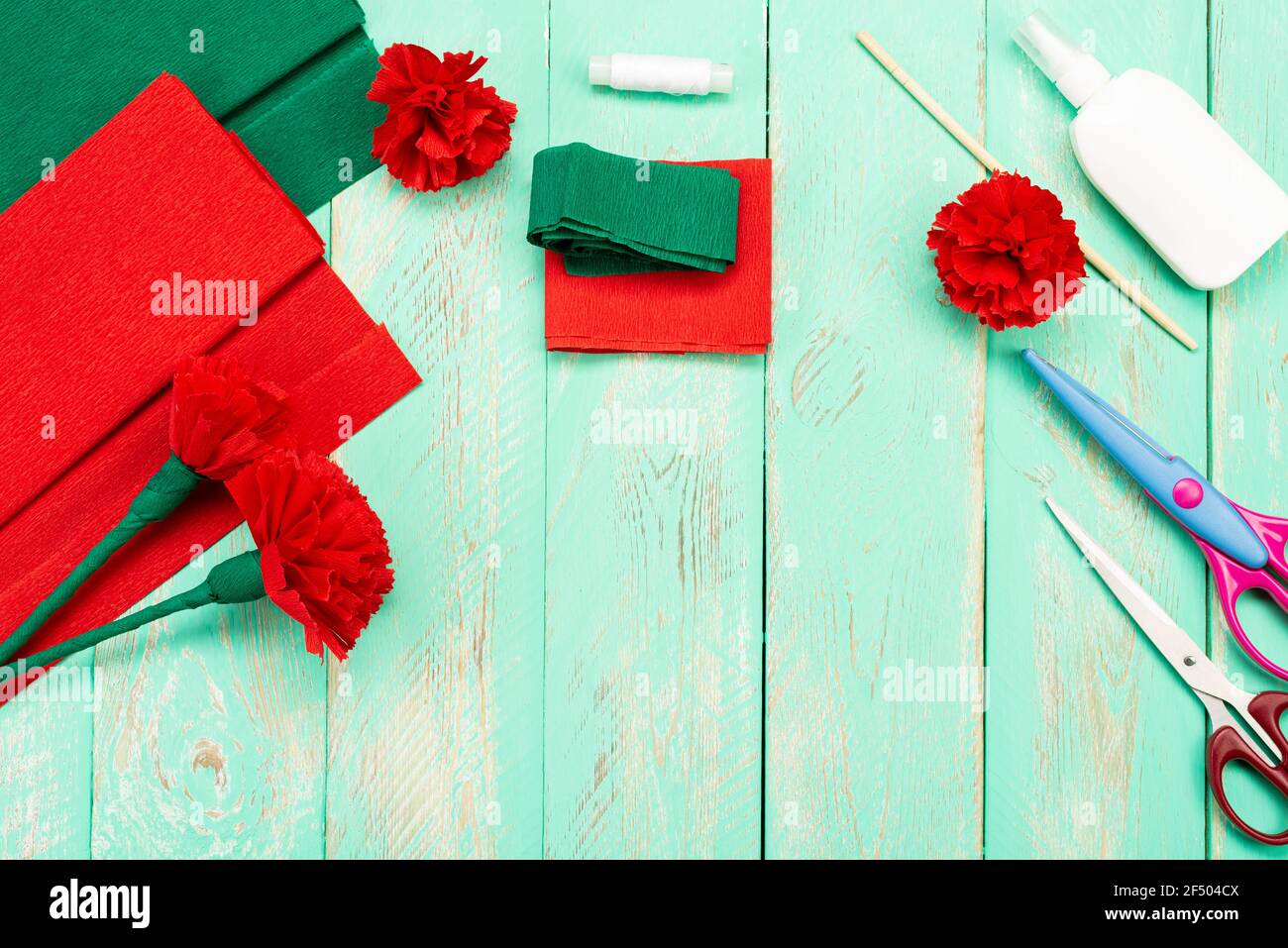 How to make a carnation flower at home. Hands make a red carnation ...