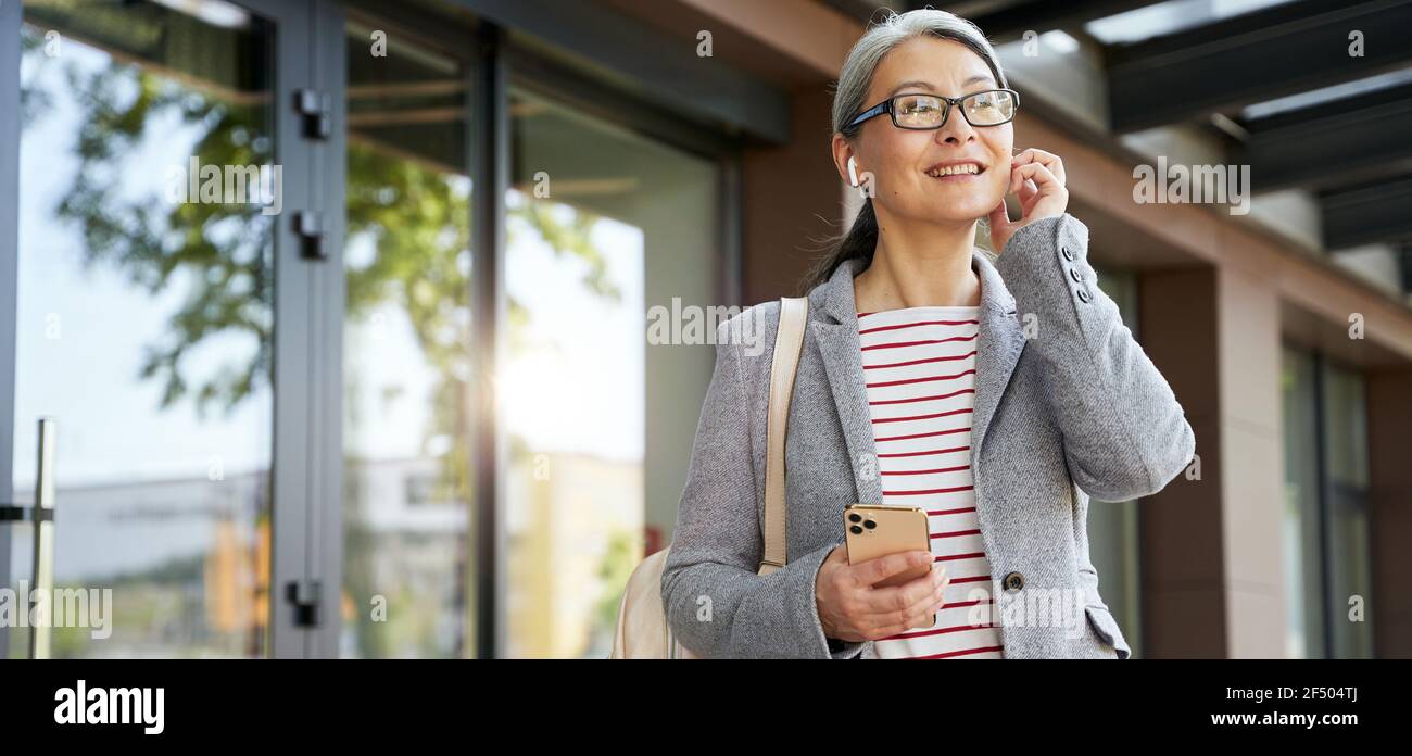 Radiant middle-aged woman enjoying a walk outside Stock Photo - Alamy
