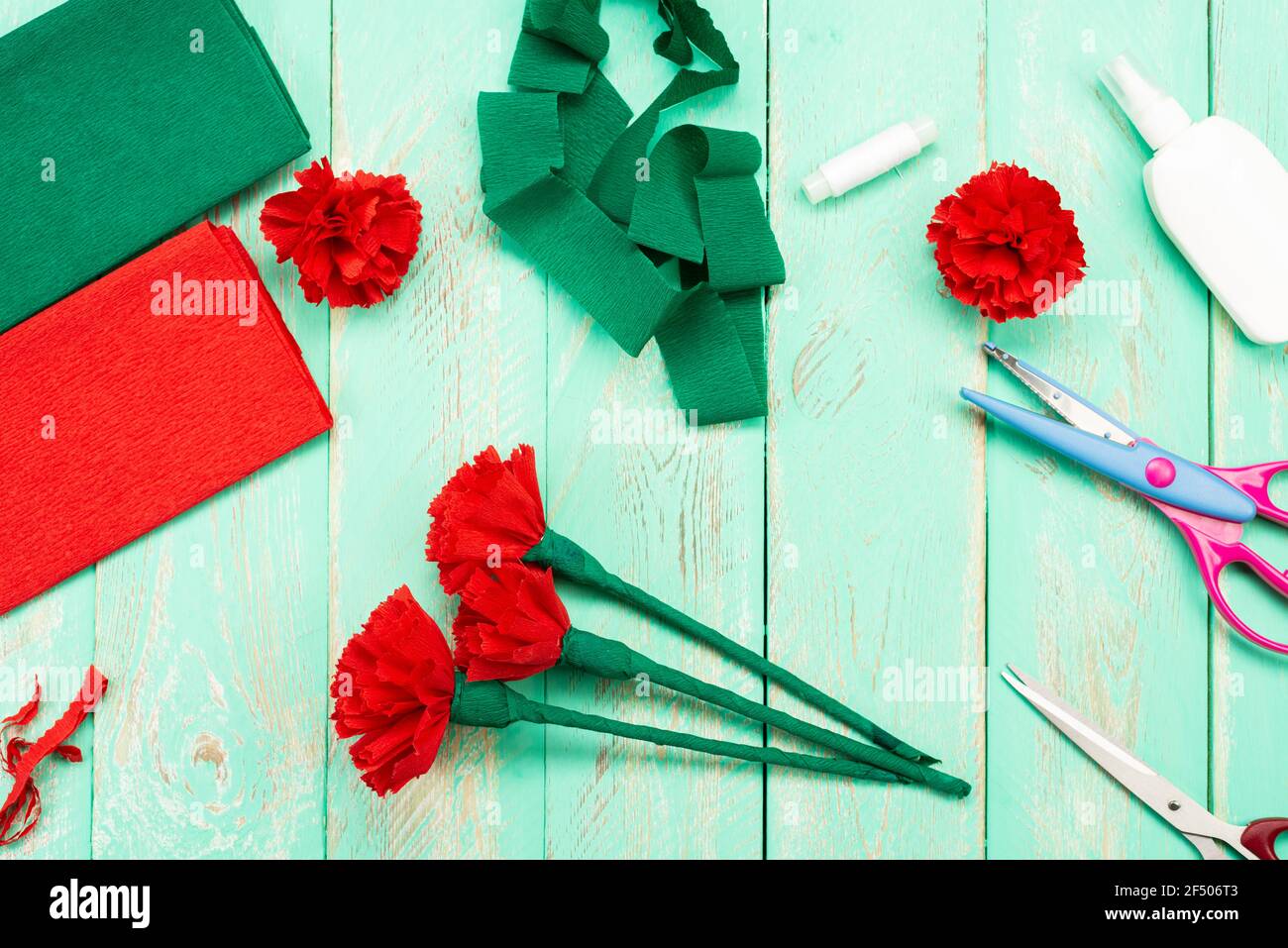 How to make a carnation flower at home. Hands make a red carnation ...