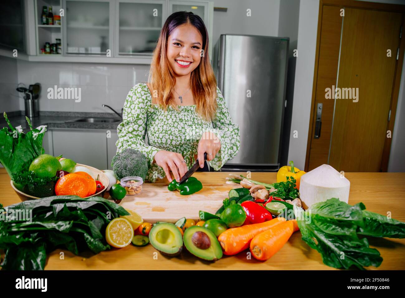 Asian girl cooking healthy vegetarian and vegan food, vegetables and ...