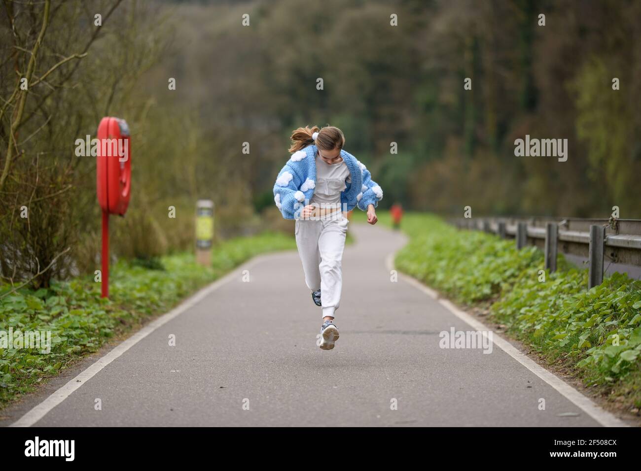 Girl running on a path Stock Photo - Alamy