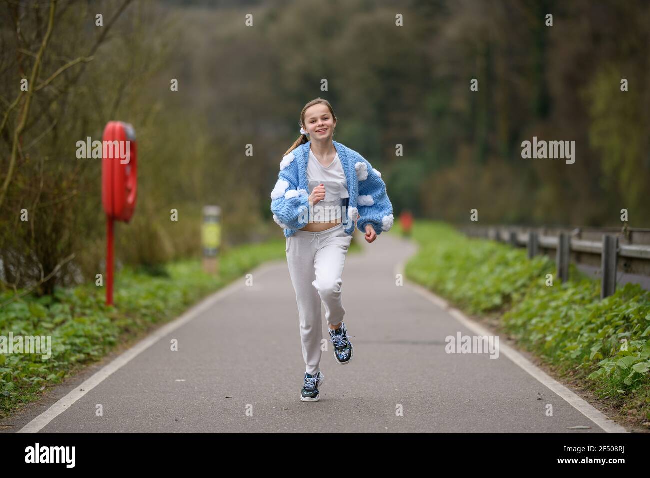 Girl running on a path Stock Photo - Alamy